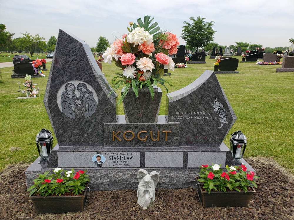Blue granite wing monument with Polish lettering, holy family carving ...
