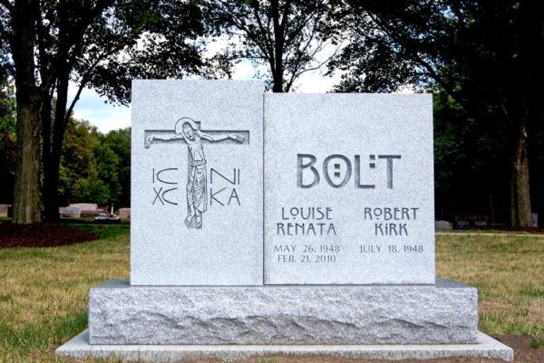 Contemporary grey granite monument for two graves with Jesus on cross ...