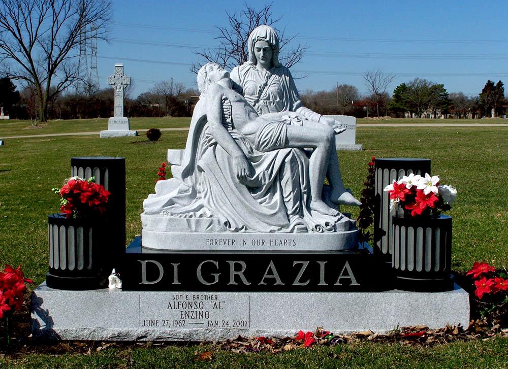 Black and grey monument with Pieta sculpture and fluted columns ...
